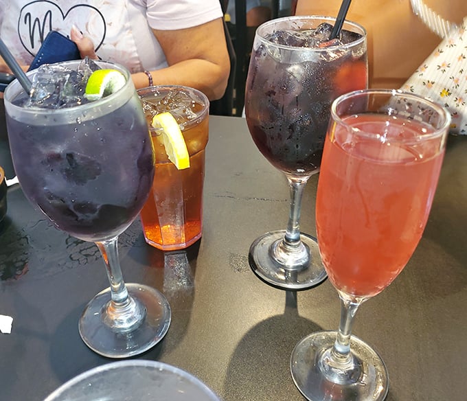 Weekend brunch cocktails lined up like colorful soldiers ready to battle your weekday stress – the pink one's already winning.