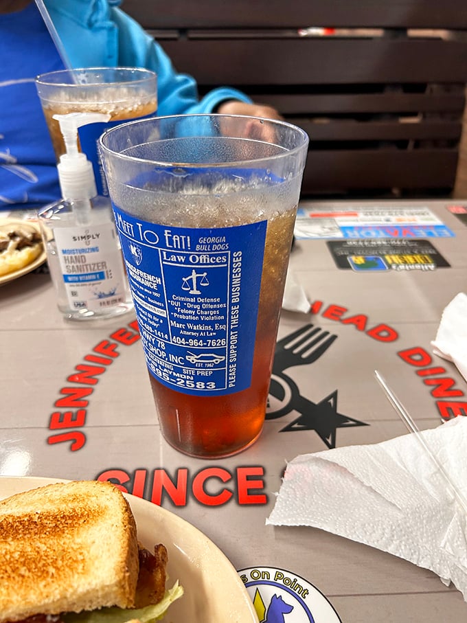 Sweet tea served in glasses advertising local businesses—the most authentic Southern beverage delivery system ever invented.