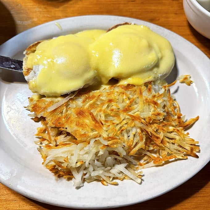 Eggs Benedict with hash browns crispy enough to make a satisfying crunch heard three tables away. Morning symphony on a plate.