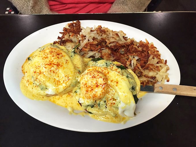 Eggs Florentine that would make Popeye weep with joy—golden hollandaise cascading over perfectly poached eggs alongside crispy hash browns.