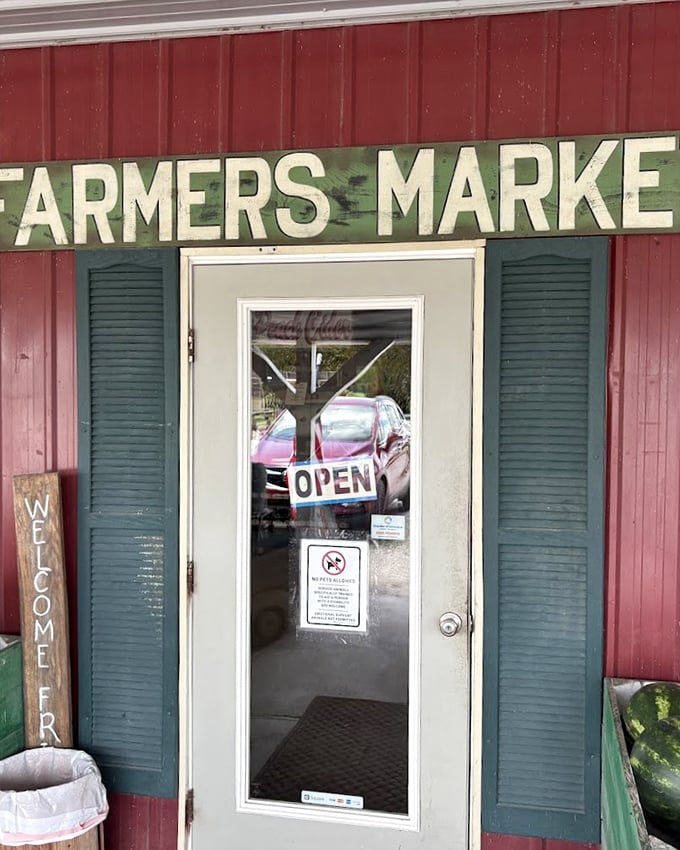 That classic red barn siding and weathered "Farmers Market" sign promise authentic country treasures within—no big-box homogeneity here!