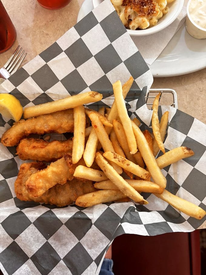 Golden-battered fish nestled among perfectly crisp fries—the kind of basket that makes you temporarily forget that vegetables exist.