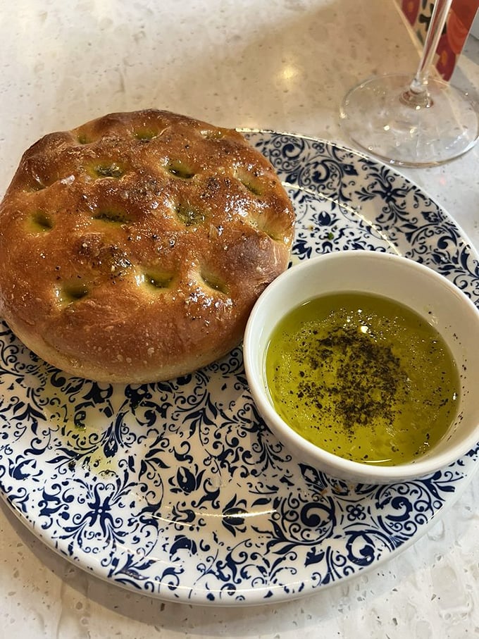 This isn't just focaccia—it's a golden-brown masterpiece with its own dipping pool of olive oil. Carb-counting is officially suspended for the evening.