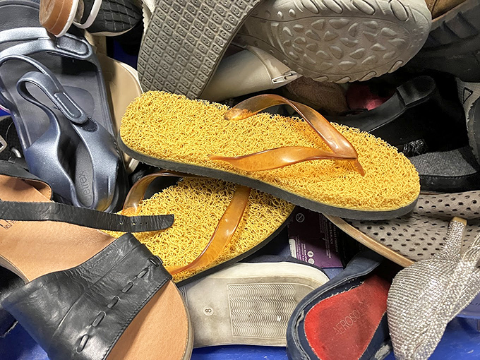 A jumble of footwear tells a hundred stories. Each pair once walked different paths—now waiting for new adventures with bargain-savvy feet.