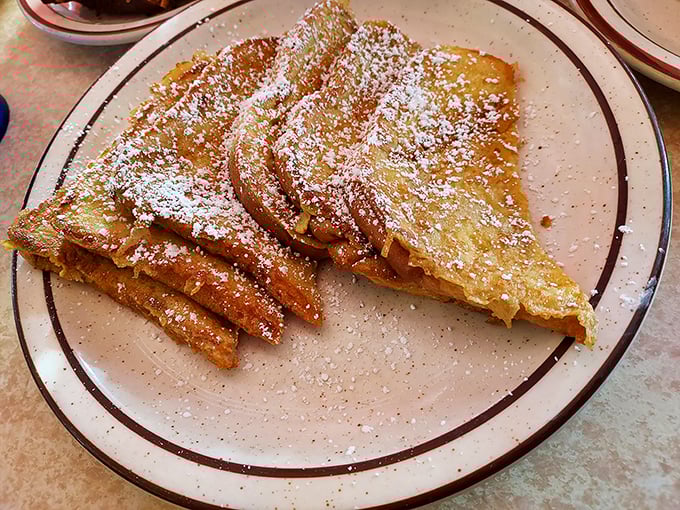French toast dusted with powdered sugar like fresh snow on a winter morning—breakfast that doubles as dessert.