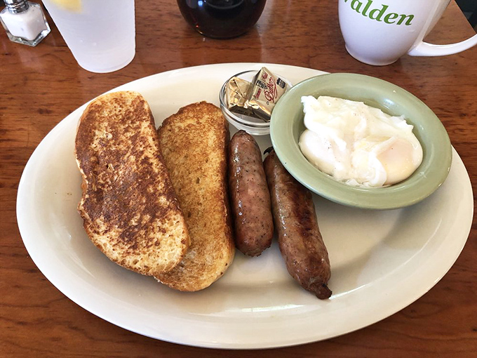 Breakfast sausage links standing at attention next to golden toast and poached eggs—the morning equivalent of a perfectly tailored suit.