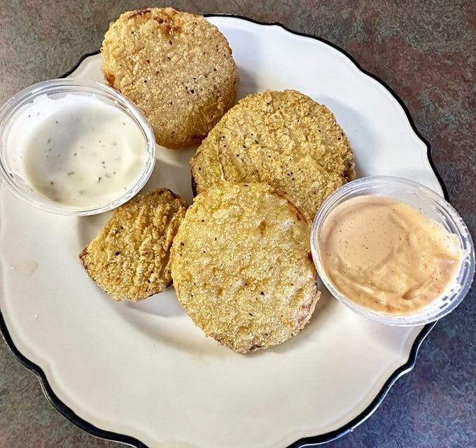Fried green tomatoes with dipping sauce – the South's gift to civilization and proof that unripe fruit can become something magical.
