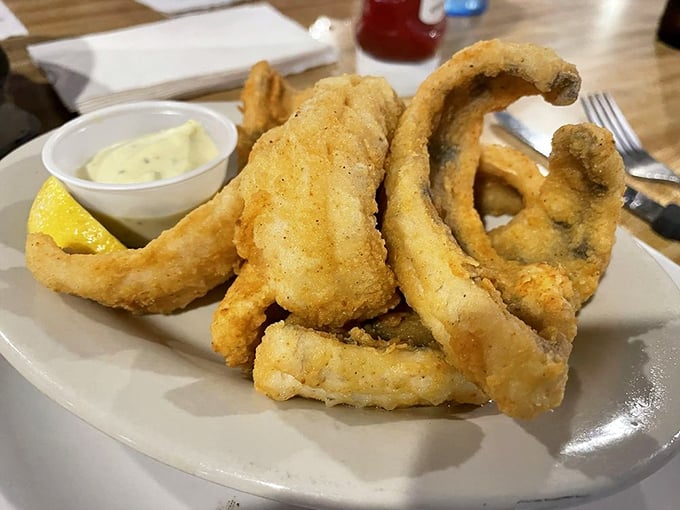 Golden-battered fish so crispy you can hear the crunch from three tables away – lake-to-plate perfection.