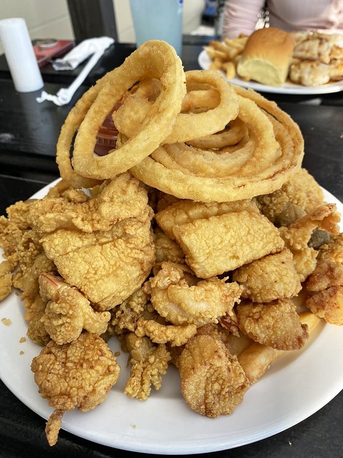 Fried seafood piled high with those signature onion rings—a tower of crispy goodness that makes you want to build a shrine to the fryer.