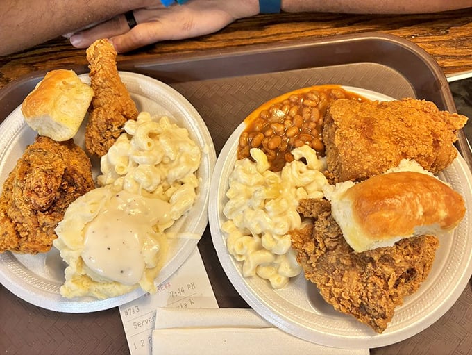 Southern comfort arranged on a plate—crispy chicken, creamy mac and cheese, and mashed potatoes that could solve world peace if given the chance.