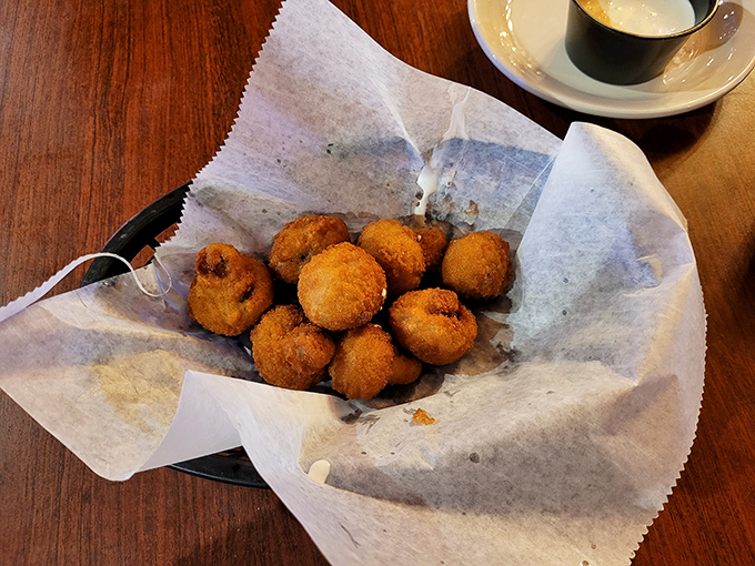 Golden-fried mushrooms arrive crispy and hot, perfect for those who believe vegetables taste better when properly breaded.