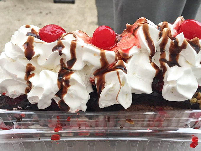 A brownie sundae that doesn't just end a meal—it creates a memory, complete with whipped cream peaks and cherry-topped chocolate drizzles.