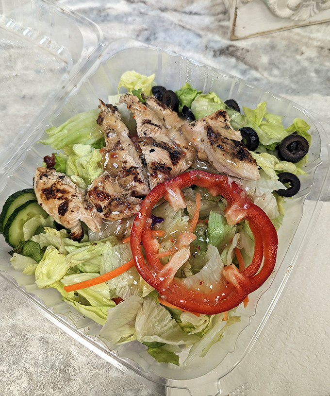 A Greek salad that brings Mediterranean sunshine to Pittsburgh – crisp vegetables, grilled chicken, and olives that didn't come from a can.