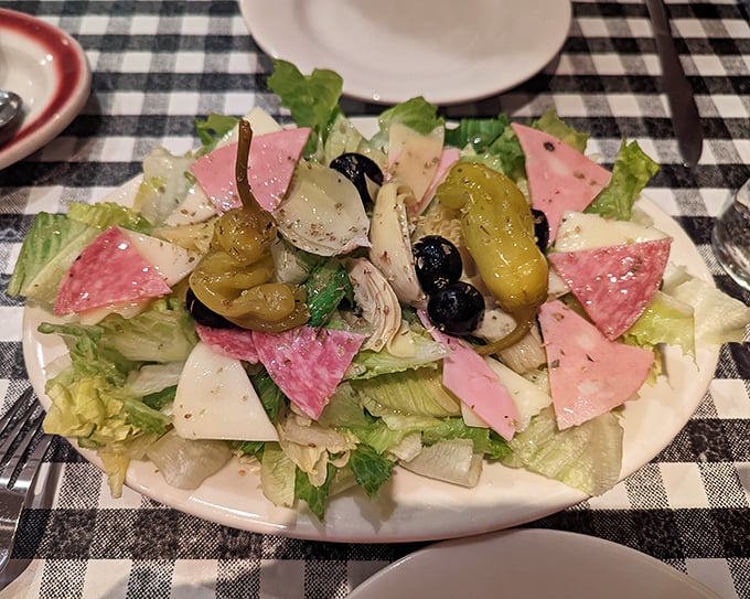 This antipasto salad provides the illusion of virtue before diving into carb heaven—colorful, fresh, and the perfect opening act.