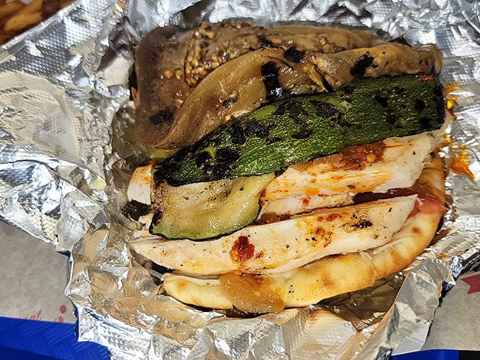 Grilled vegetables and chicken embrace in a warm flatbread—the healthier option that somehow doesn't feel like punishment.