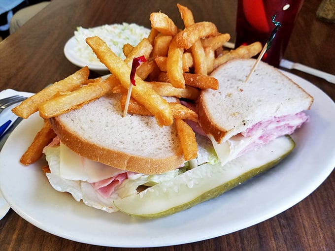 This sandwich isn't just stacked—it's architecturally significant. Those fries could make a potato weep with pride at what it became.