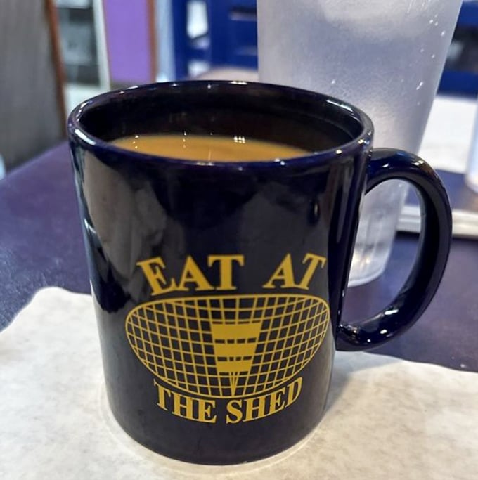 The coffee mug says it all—this isn't just a caffeine delivery system, it's part of The Shed experience.