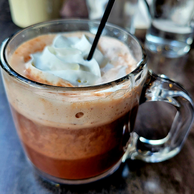 Hot chocolate topped with a cloud of whipped cream—proof that sometimes the simplest pleasures are the most satisfying. Childhood nostalgia in a sturdy mug.