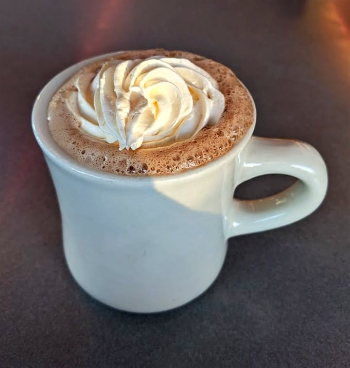 Hot chocolate that wears its whipped cream crown with dignity—winter comfort in a mug that makes Swiss Miss weep with inadequacy.