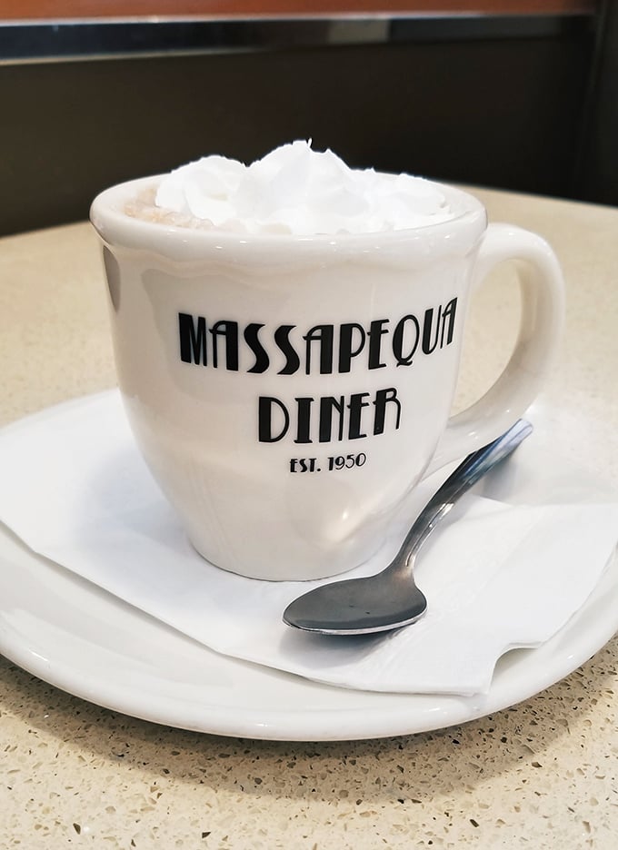 Hot chocolate that wears its whipped cream like a jaunty hat. The mug proudly announces its heritage—a vessel of comfort since 1950.