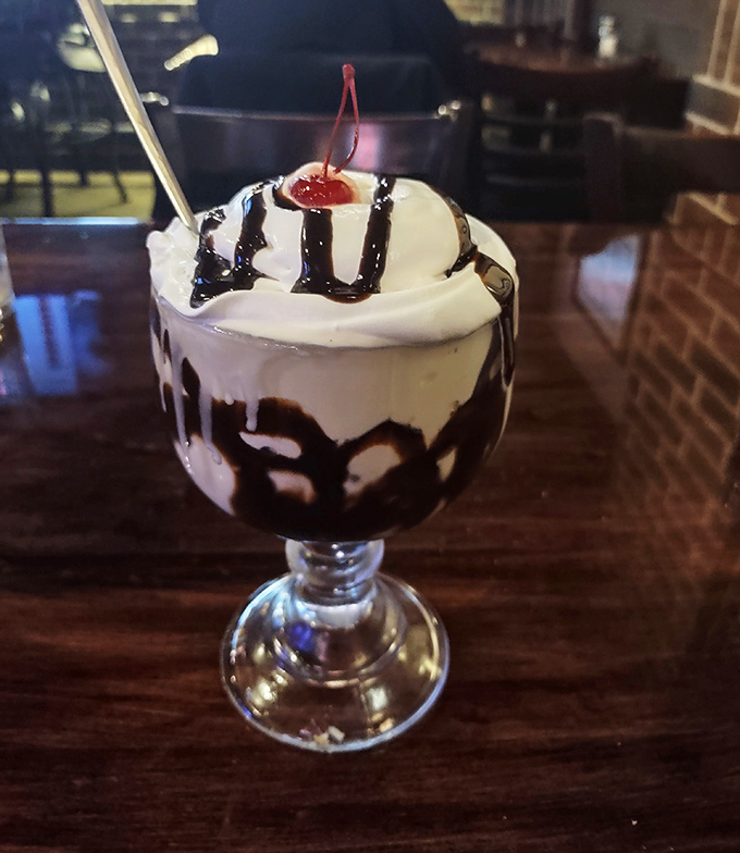 Dessert here isn't an afterthought—this hot fudge sundae with its rivers of chocolate and cloud of whipped cream is the grand finale your meal deserves.