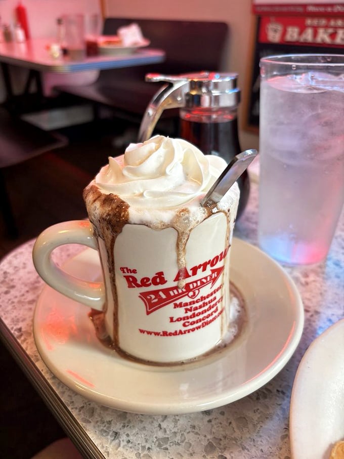 Hot chocolate at Red Arrow isn't just a beverage—it's an event, complete with whipped cream mountain and a mug that doubles as a souvenir.