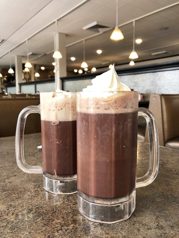 Hot chocolate that understands its assignment—topped with whipped cream mountains that would make the Wasatch Range jealous of their majesty.