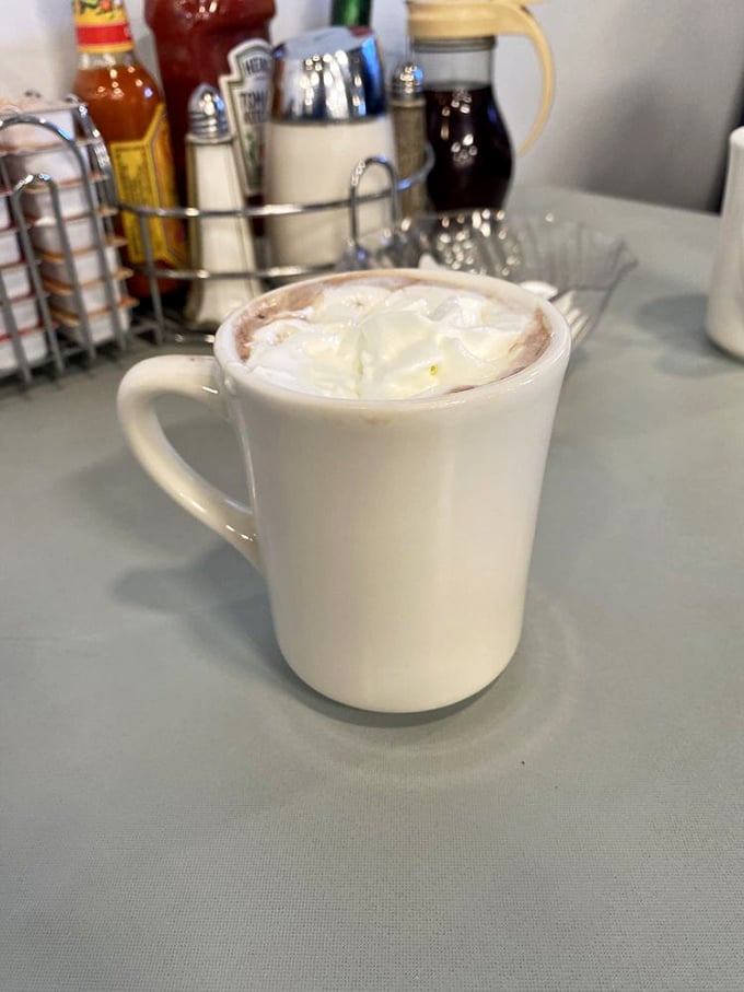 Hot chocolate that doesn't just warm your hands but restores your faith in humanity—topped with whipped cream that melts into creamy perfection.