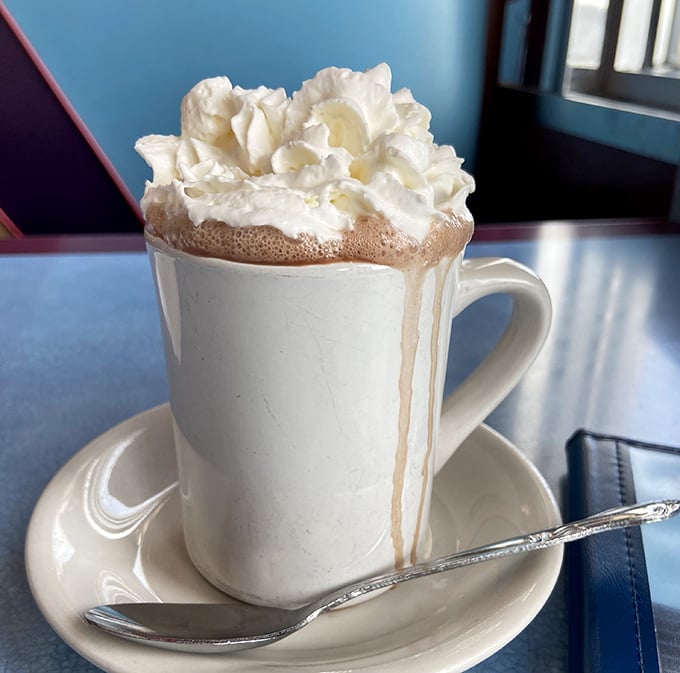 Hot chocolate that doesn't just arrive at your table – it makes an entrance, wearing a cloud of whipped cream like a fashionable hat.