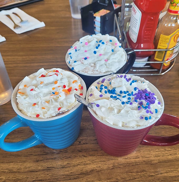 Hot cocoa gets the royal treatment with whipped cream mountains and colorful sprinkles—proof that sometimes the simplest pleasures are the most delightful.