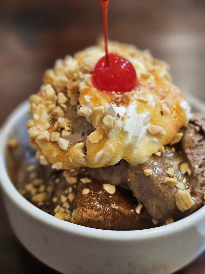 Ice cream mountains capped with whipped cream snow and chocolate lava flows—dessert geography never tasted so magnificent.