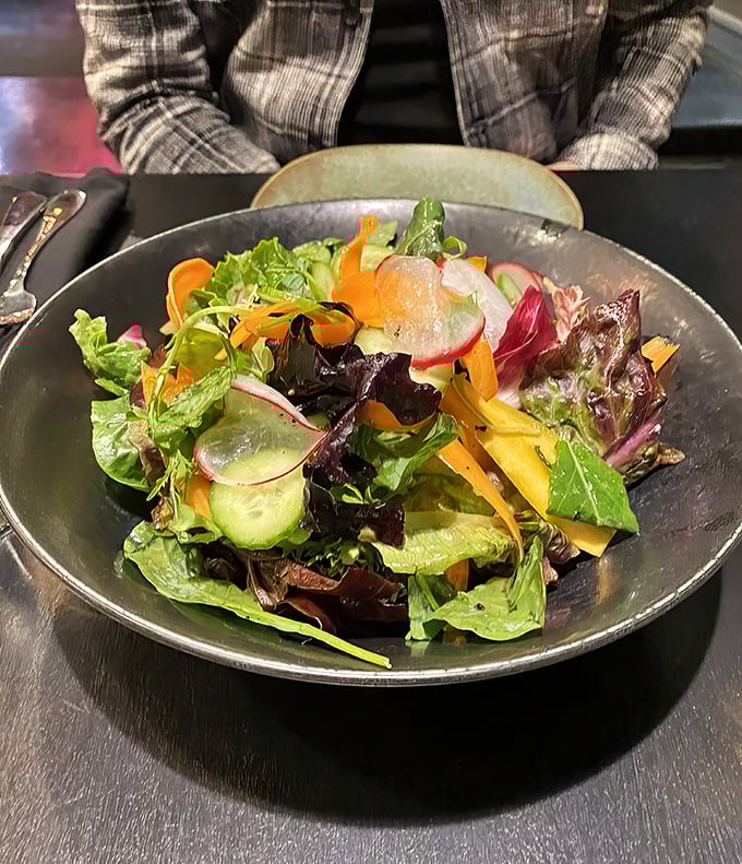 Even the salad gets the royal treatment—a fresh counterpoint that doesn't apologize for showing up at a meat party.