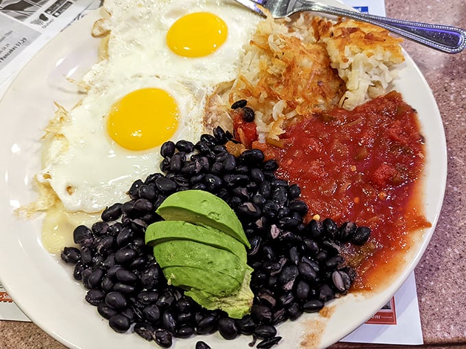 Sunny-side up eggs, black beans, avocado, and salsa – a breakfast fiesta that proves Nevada Diner's range extends well beyond traditional diner fare.