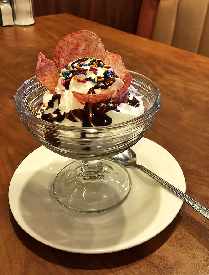 Ice cream sundae with all the fixings—because sometimes being an adult means eating dessert whenever you darn well please, especially when rainbow sprinkles are involved.