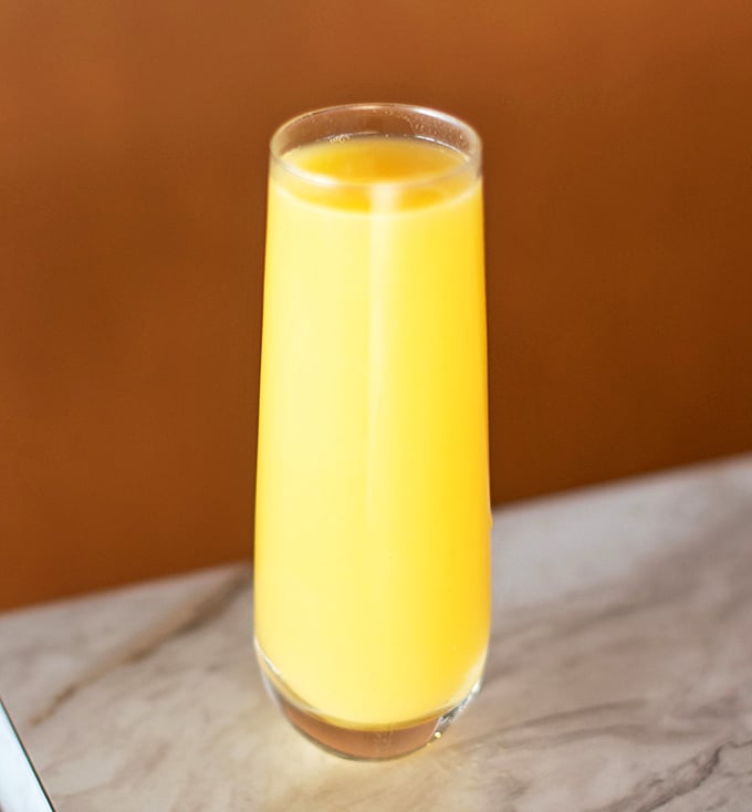 Morning sunshine in liquid form—this glass of orange juice is brighter than your future after consuming it.