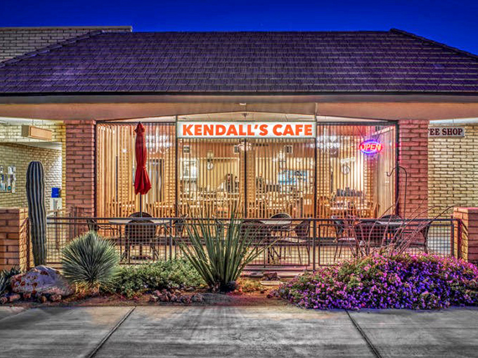 Kendall's Café glows with welcoming warmth against the desert night, promising hearty breakfasts that fuel days of exploration.