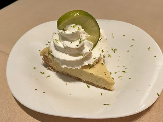 Key lime pie topped with a cloud of whipped cream and lime zest—sunshine on a plate that makes Wisconsin winters bearable.