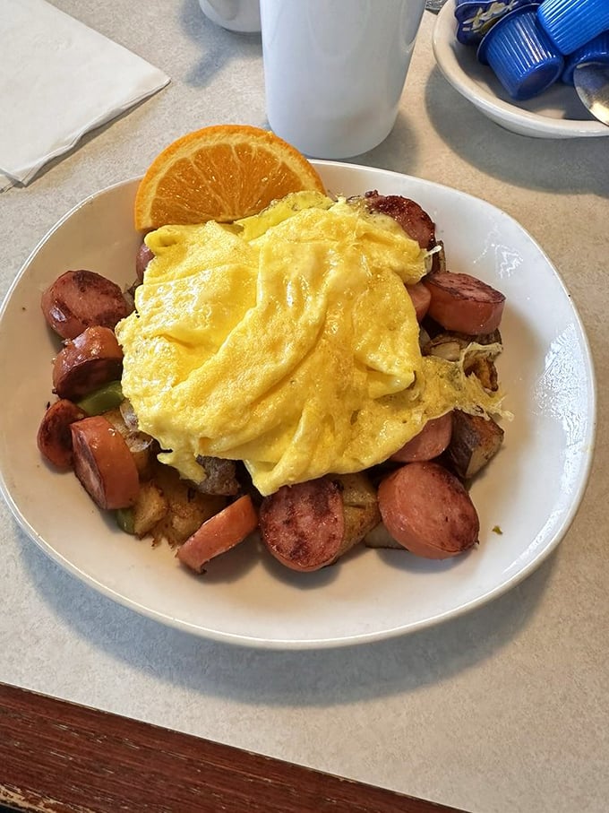 Eggs lounging atop a mountain of sausage and potatoes – the breakfast equivalent of a warm hug from someone who truly gets you.