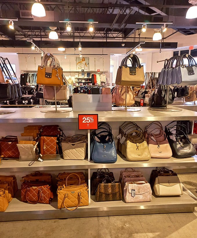 Designer handbags arranged like museum pieces, each one whispering, "Take me home, I'm 40% off regular price!"