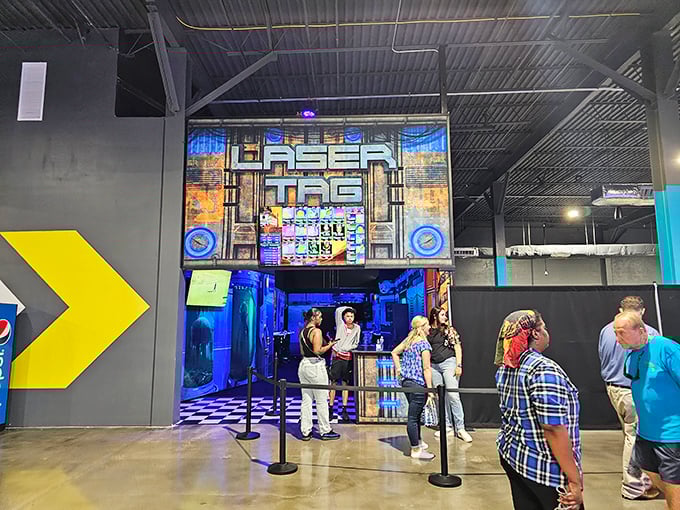The Laser Tag entrance beckons thrill-seekers with its dramatic lighting and promise of strategic warfare where office politics are temporarily replaced by laser diplomacy.