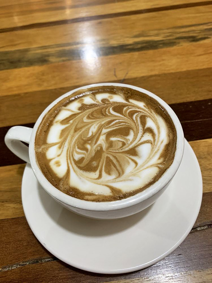 Coffee elevated to art form—this latte's swirling pattern hypnotizes while promising the caffeine kick needed for desert adventures ahead.