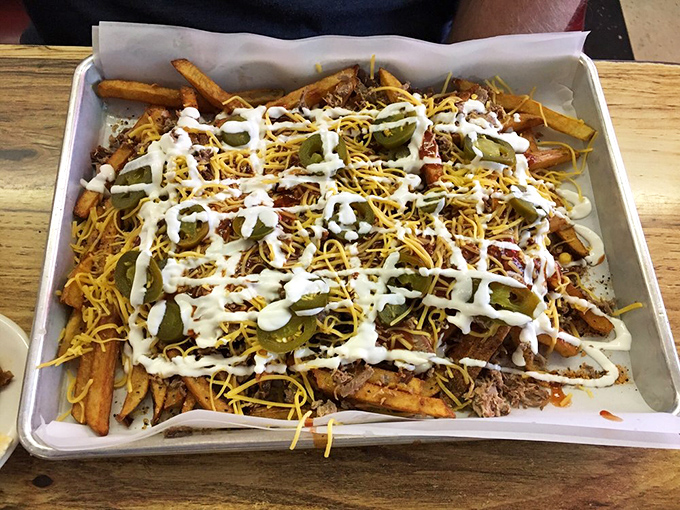 Loaded fries that laugh in the face of moderation. Cheese, jalapeños, pulled pork, and sauce create a beautiful mess worth every napkin.