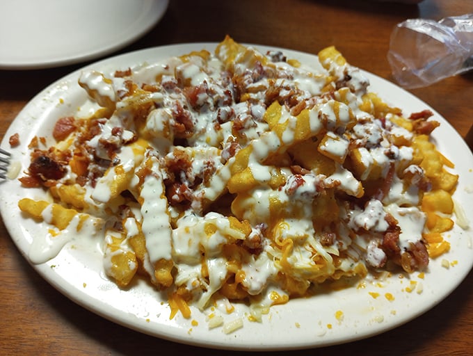 Not just loaded fries—these are a cheesy, bacon-topped monument to the principle that sometimes more really is more.