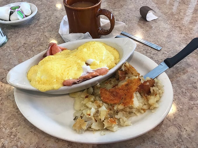 An omelet that's dressed for success—fluffy eggs cradling ham, perfectly paired with those legendary home fries that steal the show.
