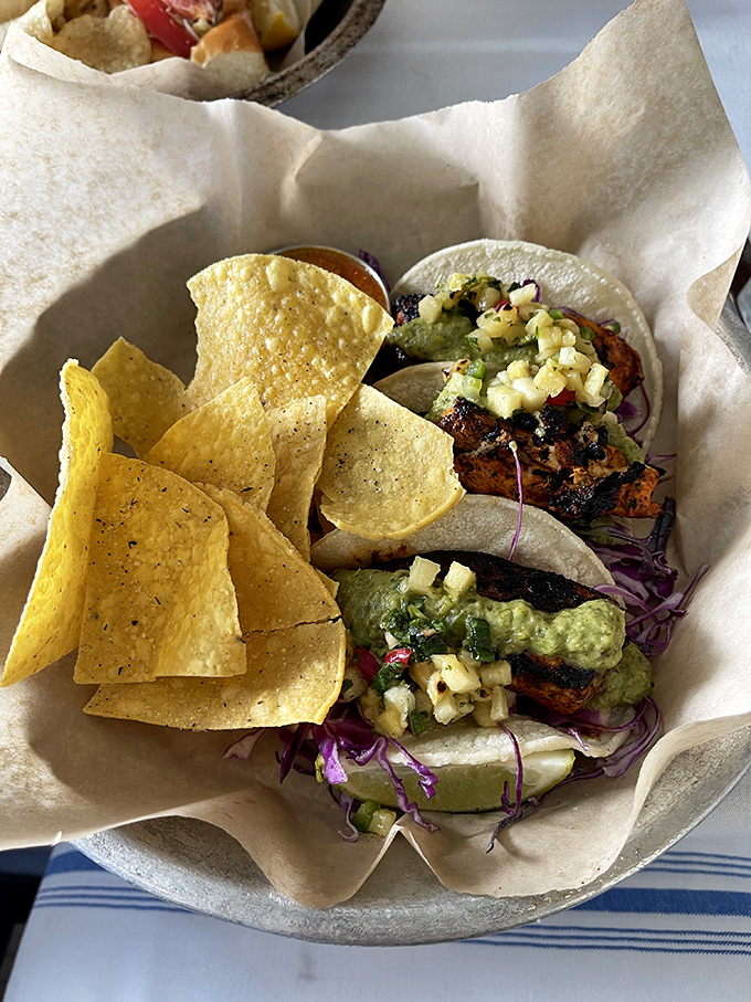 These mahi tacos aren't just lunch, they're a vacation on a plate – grilled fish, crunchy slaw, and that pineapple salsa bringing tropical vibes to every bite.