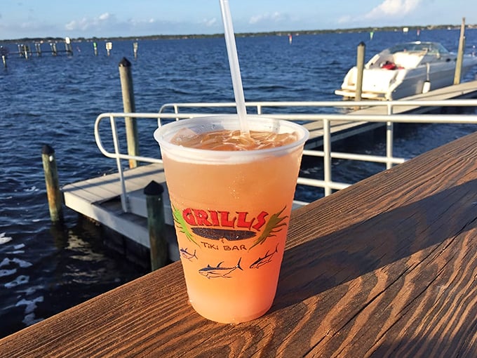 A sunset-colored cocktail with the Grills logo—because drinking from a regular glass when you're waterside would just be wrong.