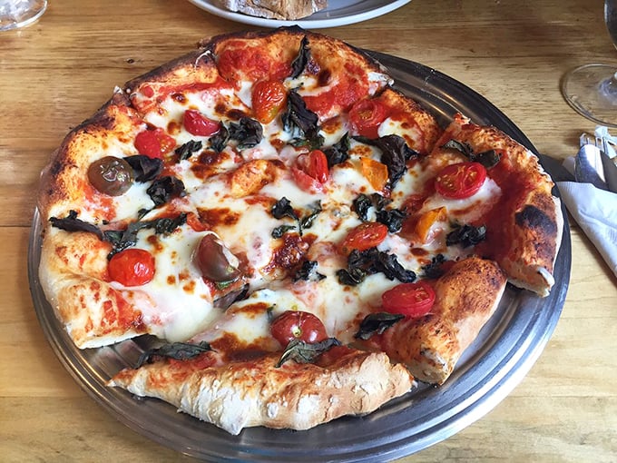 Fresh tomatoes and basil dancing atop melted cheese—this margherita pizza is summer sunshine in edible form.