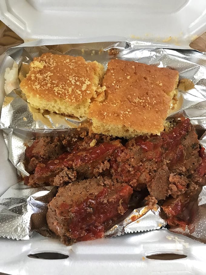 The meatloaf arrives thick, hearty, and smothered in gravy that could make cardboard taste like heaven.