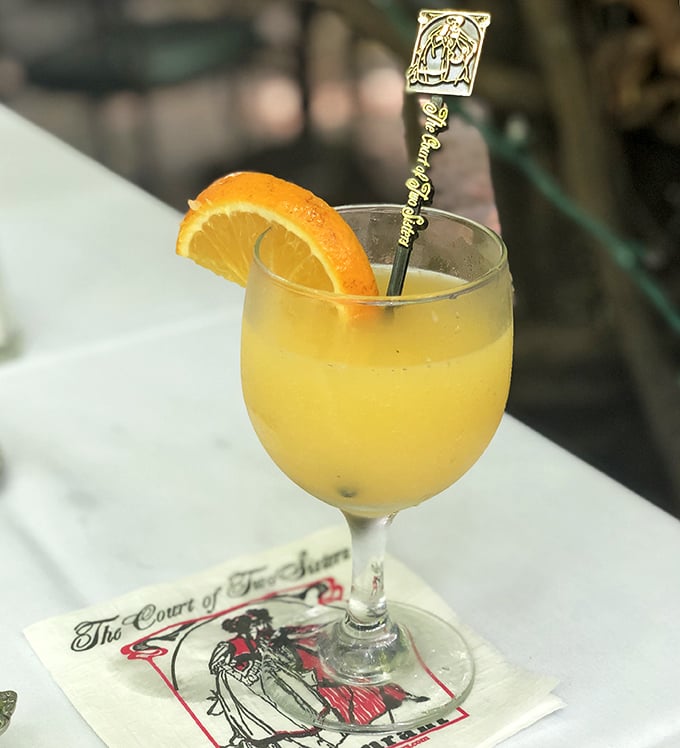 A mimosa at Court of Two Sisters isn't just a brunch cocktail—it's liquid sunshine in a glass, complete with a souvenir stirrer.