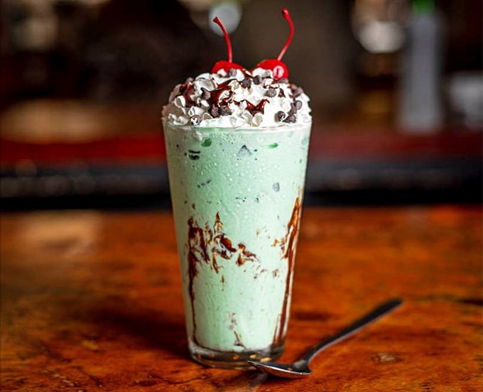 The mint chocolate chip milkshake that makes adults forget their dignity – suddenly you're eight years old again, racing to finish before it melts.